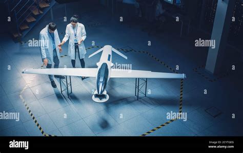 Two Aerospace Engineers Work On Unmanned Aerial Vehicle Drone Prototype