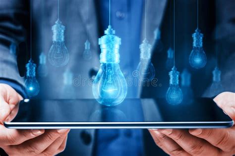 close up of businessman hand holding tablet with glowing digital lamp