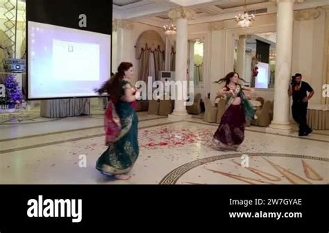 Two Girls In Traditional Costumes Dance Oriental The Banquet