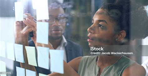 브레인스토밍 또는 계획을 위해 사무실에서 비즈니스 사람들과 협업 유리잔 및 회의 코칭 개발 또는 교육 및 스티커 메모로 쓰기위한 직장의 아프리카 직원 그룹 20 24세에