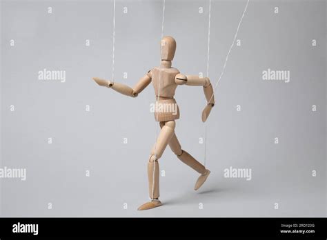 One Wooden Puppet With Strings On Light Grey Background Stock Photo Alamy