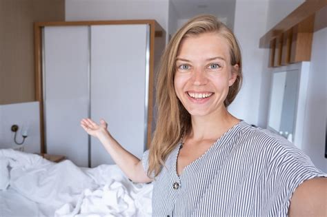 Premium Photo Happy Woman Showing Her Hotel Room Taking Selfie