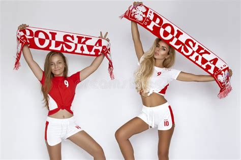 Polish Girls In Sports Outfits Hold The Polish Red And White Flag And