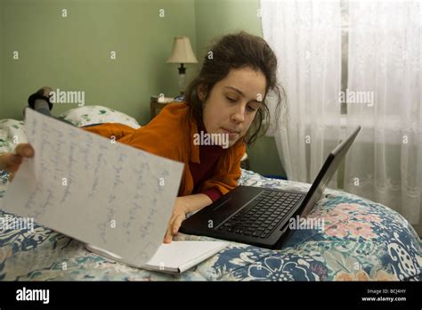 Female College Babe Works On A Wireless Internet Network On Her Bed In New York City Stock