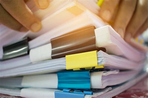 사업가 손 작업 책상 사무실 비즈니스 보고서 논문에 대 한 정보를 검색 하기 위한 종이 파일 더미에서 일의 미완성된 문서 더미 클립 실내 비즈니스 개념 달성 과로에 대한