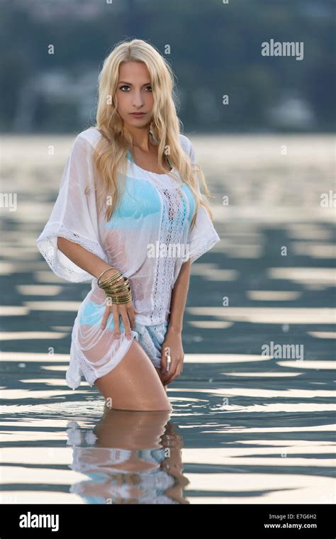 Woman Wearing A Light Blue Bikini Under A White Transparent Shirt Stock Photo Alamy