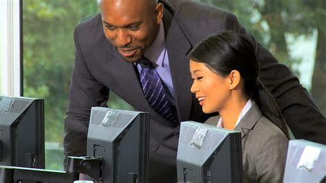 Female African American Sales Manager Giving Male Caucasian Team Member Latest Sales Targets