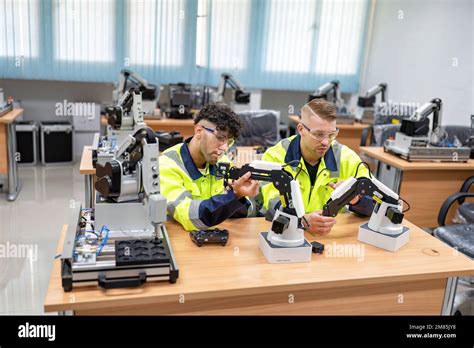 engineer learn basic theory how to operation maintenance and programing robot arm in training