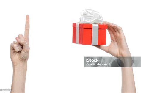 축 하와 선물의 테마 흰색 리본 및 활 스튜디오에서 흰색 배경에 고립 된 가장 아름 다운 선물 빨간색 상자에 포장 하는 선물을 들고 손 기념일에 대한 스톡 사진 및 기타