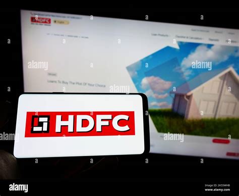 Person Holding Cellphone With Logo Of Housing Development Finance Corporation Hdfc On Screen