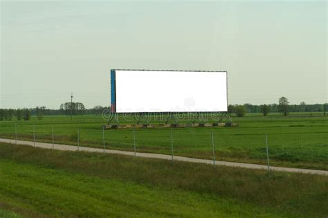 Giant Billboard Prominently Displayed Alongside Busy Road Stock Image