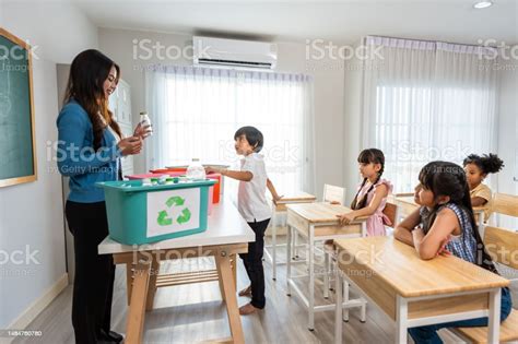 초등학교 교실에서 교사와 함께 배우는 학생 그룹 매력적인 미인 여성 강사 마스터는 유치원에서 행복과 재미있는 활동으로 어린