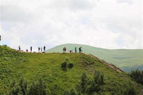 Premium Photo A Group Of People Stand On A Hill One Of Which Is