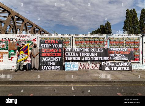 Activists Nick Weeden And Khalid Malik Stand Next To Anti Beijing