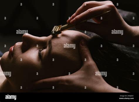 Soft Light Image Of A Woman Receiving Forehead Massage In A Beauty