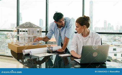 Smart Engineer Inspect House Model While Colleague Using Laptop Tracery Stock Image Image Of