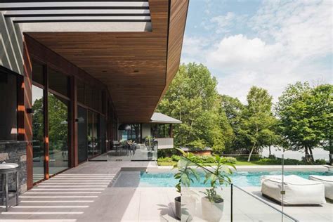 An Angular Lake House In Canada With A Cantilevered Pool