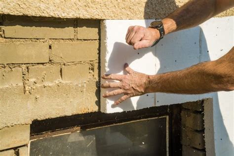 Installing Rigid Styrofoam Insulation Board For Energy Saving Of The House Wall Stock Image