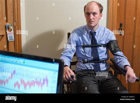 Man Being Examined Using A Polygraph Test Lie Detector Machine Which