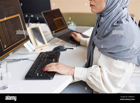 Closeup Of Muslim Young Woman Working As Female Software Developer And Writing Code With
