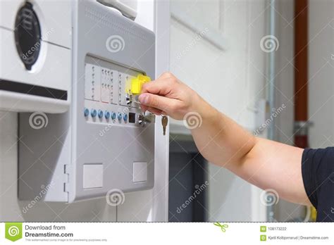 Close Up Of Service Technician Opening Fire Panel In Server Room Stock