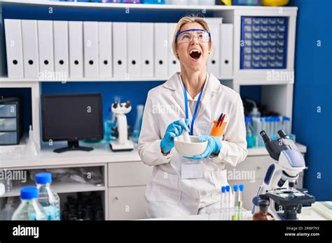 Young Caucasian Woman Working At Scientist Laboratory Angry And Mad Screaming Frustrated And