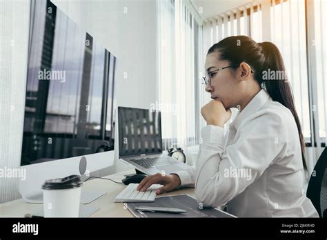 Asian Female Software Developer Is Worried About Analyzing Code Based Systems At His Office