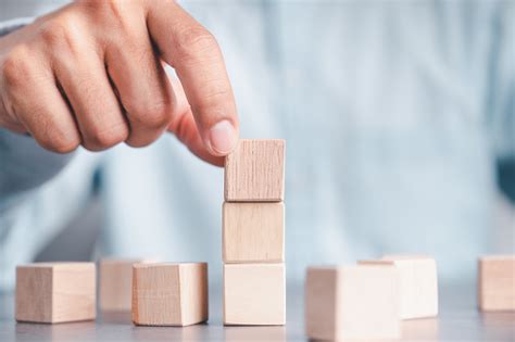 파란 셔츠를 입은 사업가가 빈 나무 블록을 손으로 정리했다 흰색 나무 테이블에 배치됩니다 비즈니스 전략 및 실행 계획 공간을 복사합니다 개념에 대한 스톡 사진 및 기타