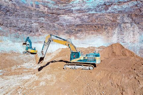 Premium Photo Open Pit Mine In Full Operation With Machinery Extracting Minerals