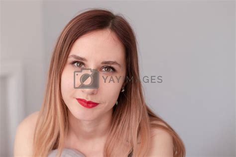 Portrait Of Pretty Redhead Woman In Black Lingerie On Bed With Grey Sheets And Blanket By