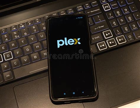 Illustration Of The Plex Logo Displayed On A Smartphone Screen Back Ground Is A Key Board
