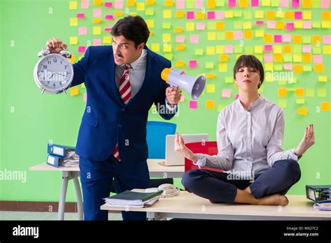 Man And Woman In The Office With Many Conflicting Priorities In Stock Photo Alamy