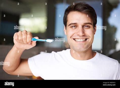Keeping The Pearly Whites Clean A Young Man Brushing His Teeth Stock
