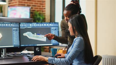 Female Engineers Analyzing Clamp Component Prototype Stock Photo