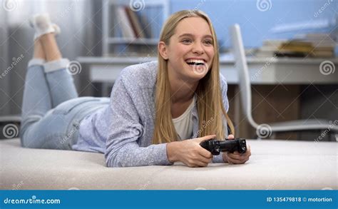 Smiling Teen Girl Gamer Playing Game With Joystick Happy To Win