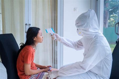 Premium Photo Medical Worker Checking Girl Body Temperature
