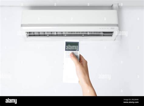 Woman Operating Air Conditioner With Remote Control Indoors Closeup Stock Photo Alamy