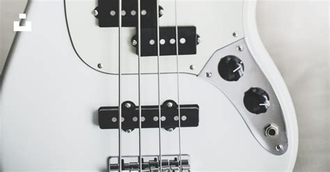 흰색 표면에 흰색과 검은색 일렉트릭 베이스 기타 사진 Unsplash의 무료 음악 이미지