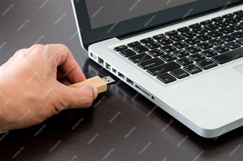 Premium Photo Hand Inserting Usb Flash Drive Into Laptop