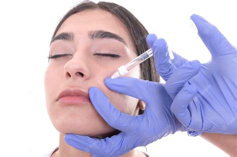 Premium Photo Young Woman Gets Injection Of Botox In Her Lips Woman In Beauty Salon Plastic