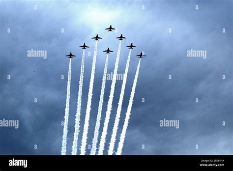 A Picture Of Several Airplanes In Formation Soaring Through The Sky With White Billowing Smoke