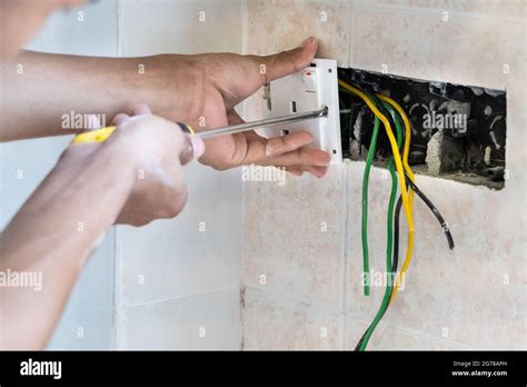 Series Of Electrician Install And Mount Electrical Power Socket Onto Wall Stock Photo Alamy