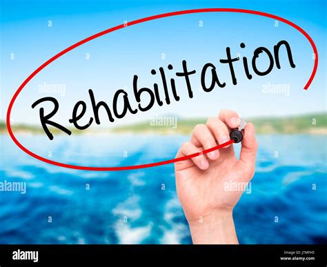 Man Hand Writing Rehabilitation With Black Marker On Visual Screen Isolated On Nature Business