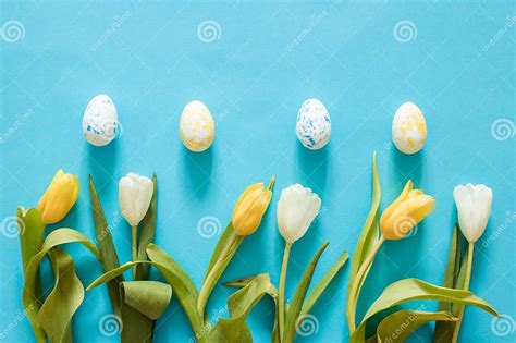 Easter Layout On Blue Background Flowers And Colorful Eggs Copy Space