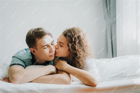Premium Photo Romantic Girlfriend Kissing Boyfriend While Lying On