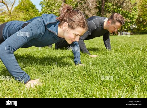 Couple Making Push Ups In The Park As Fitness Training Stock Photo Alamy