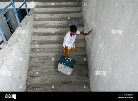 A Volunteer Carrying Units Of Electronic Voting Machine Evm From A