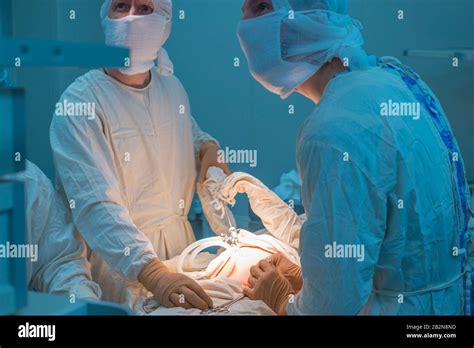 Close Up Hands Of Pediatric Surgeons Performing Surgery Using