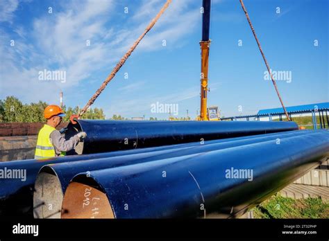 Slinger Unloads Large Gasification Pipes On Summer Day Pipes For