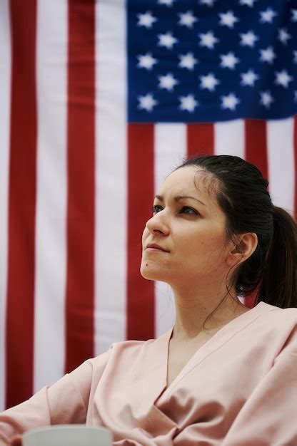 Premium Photo A Young Girl Sitting With The American Flag In The Background Concept Of America